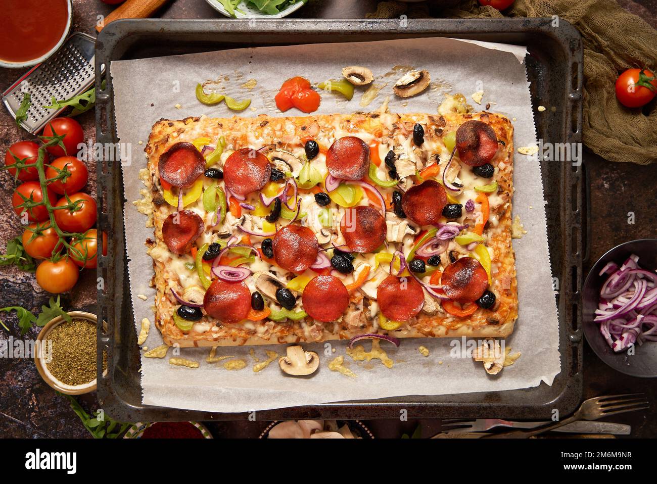 Delicious Homemade rectangular pepperoni pizza on a rustic table with ...