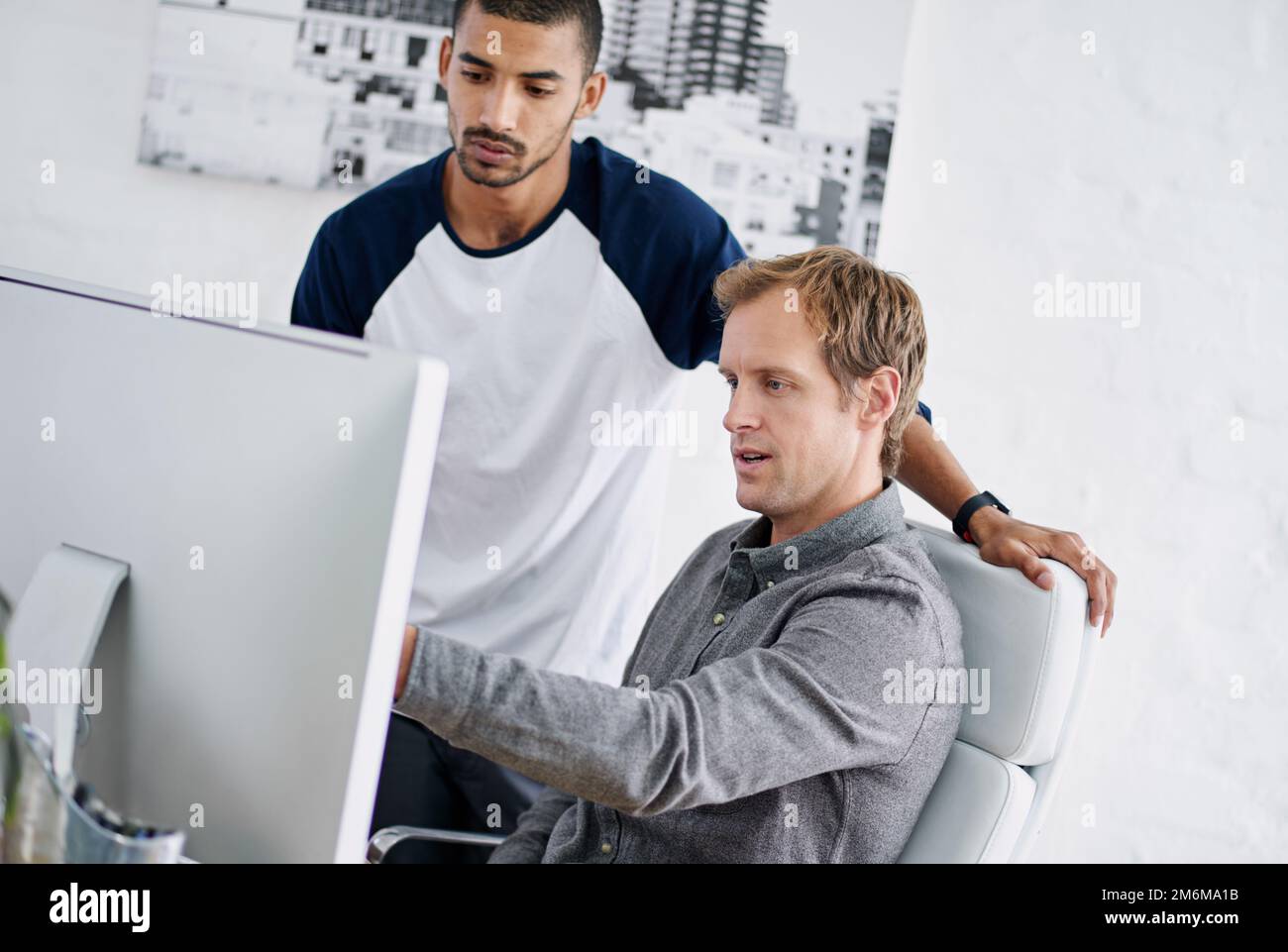 Working on their exciting new plan. two casually dressed businessmen ...