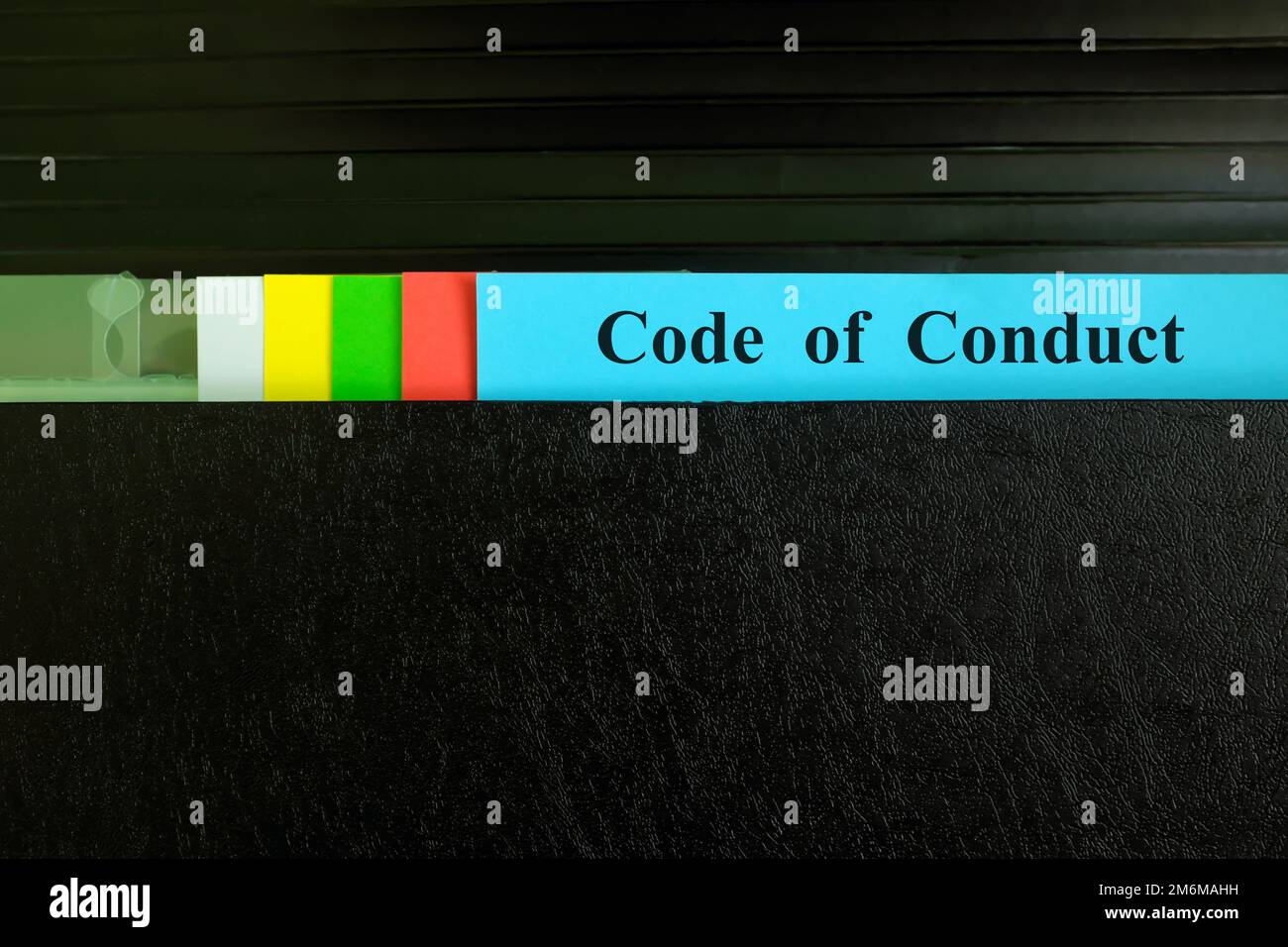 Hand picking code of conduct file record in black binder folder ... Hand picking code of conduct file record in black binder folder ...