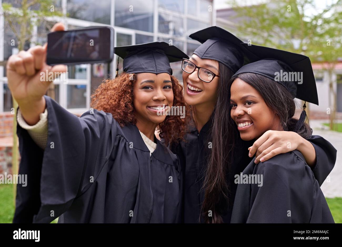 We made it to graduation. three female graduates taking a picture of ...