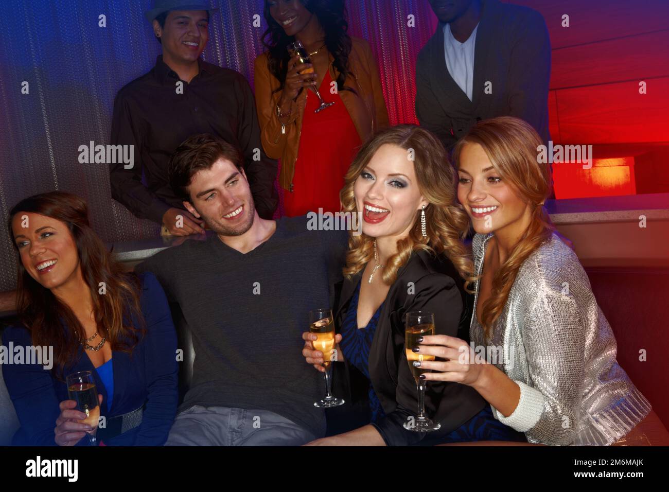 Laughing about the old days. A group of friends having drinks in a ...