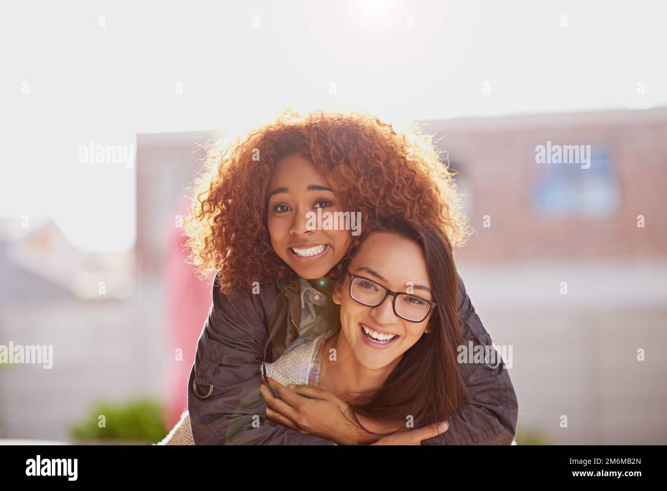 Laughter is always the best medicine. girlfriends bonding outdoors Stock Photo - Alamy