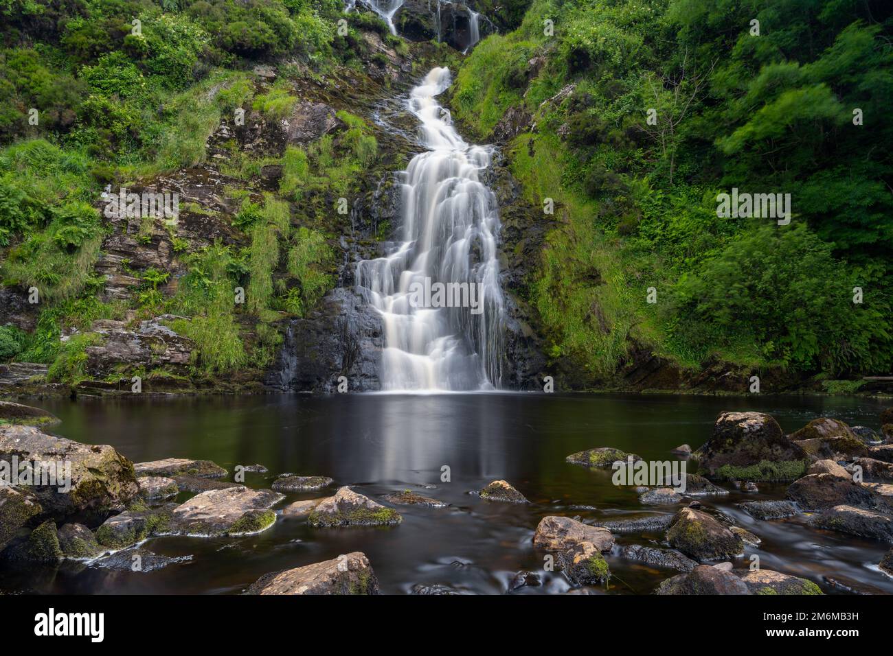 A horizontal view of the picturesque Assaranca Waterfall on the coast ...