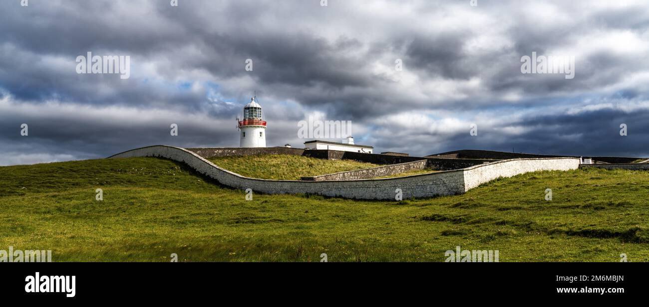 View of the historic harbor lighthouse at St. John's Point in Donegal ...