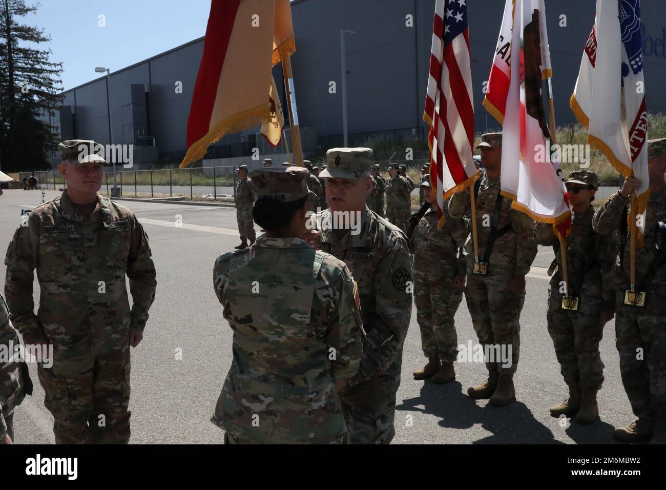 U.S. Army Command Sgt. Maj. David Eckert passes the colors to Col ...
