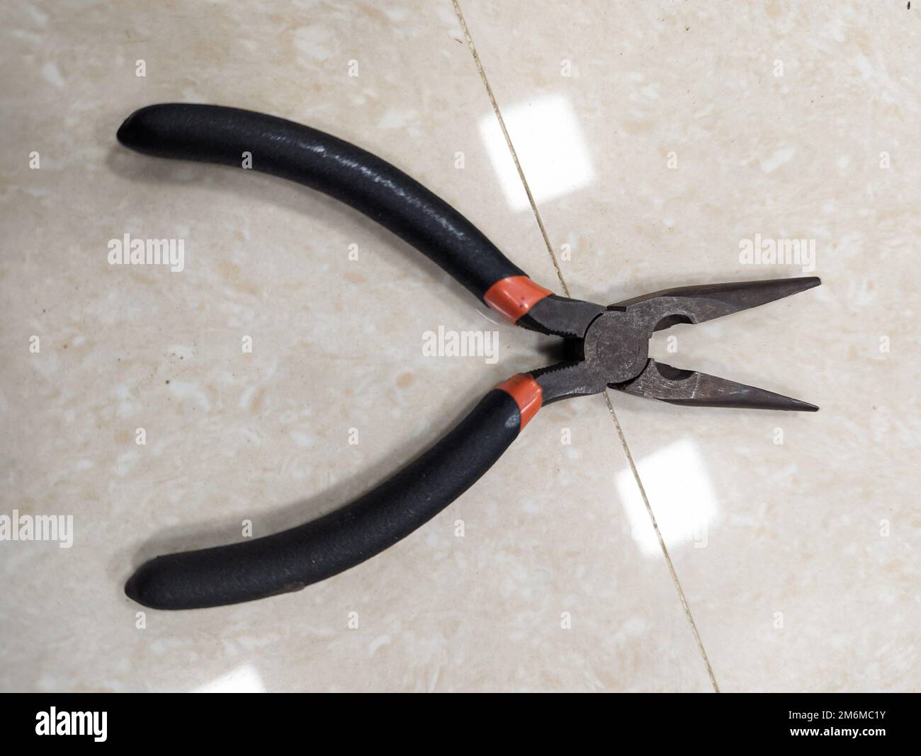 old rusty black pliers tool isolated on a the surface Stock Photo - Alamy