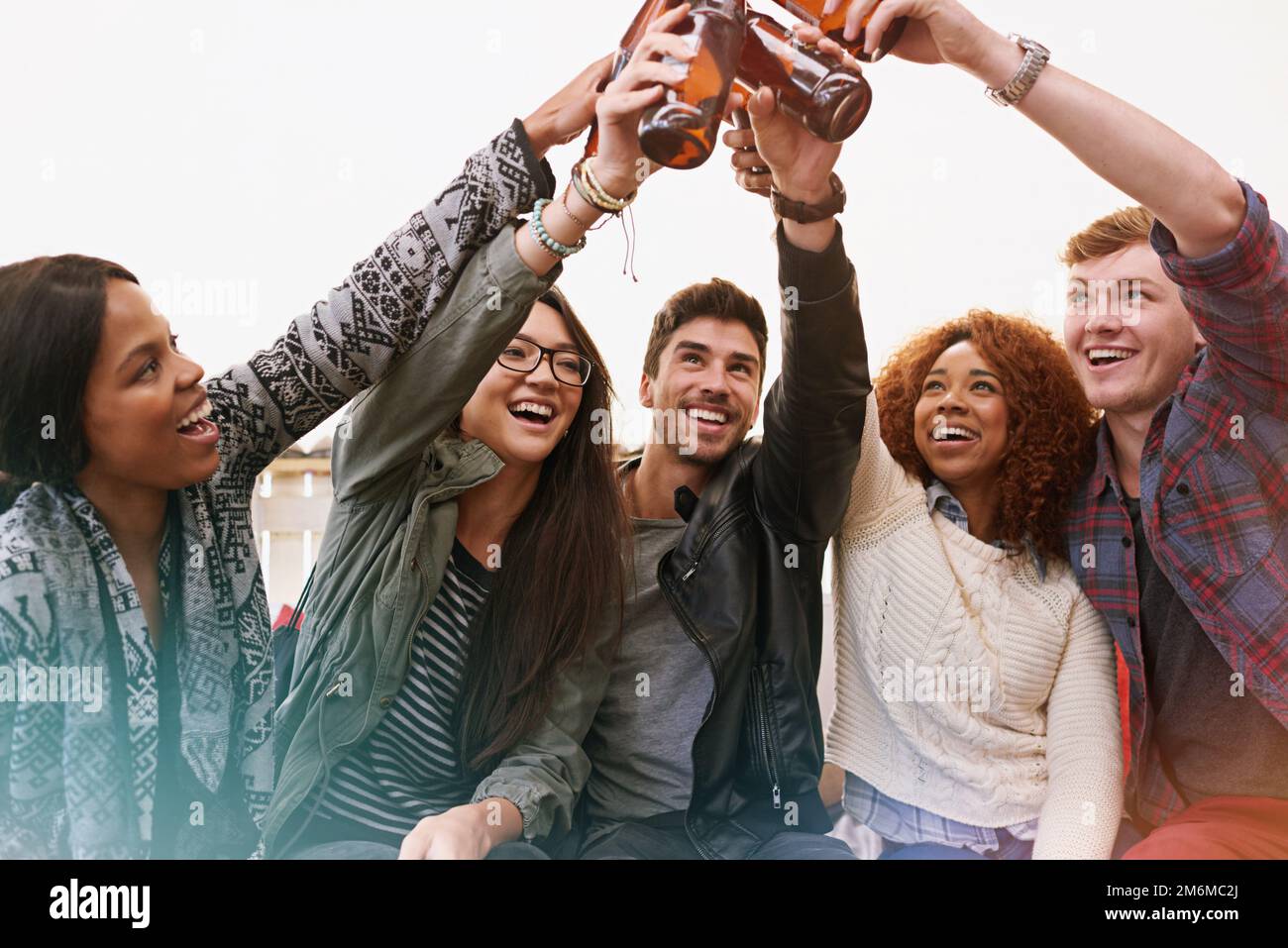 To drinking buddies. a group of friends drinking outdoors Stock Photo ...