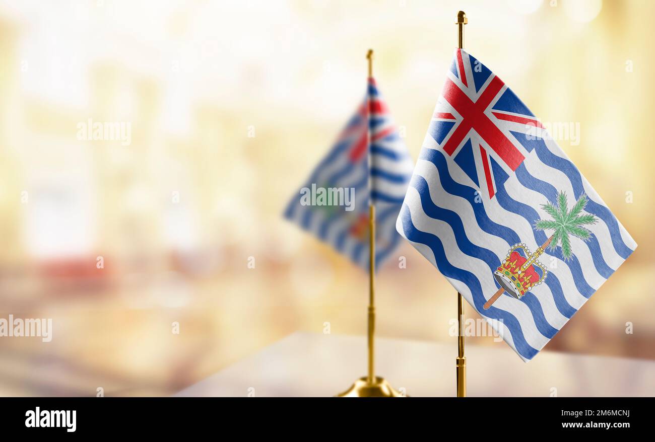 Small flags of the British Indian Ocean Territory on an abstract blurry ...