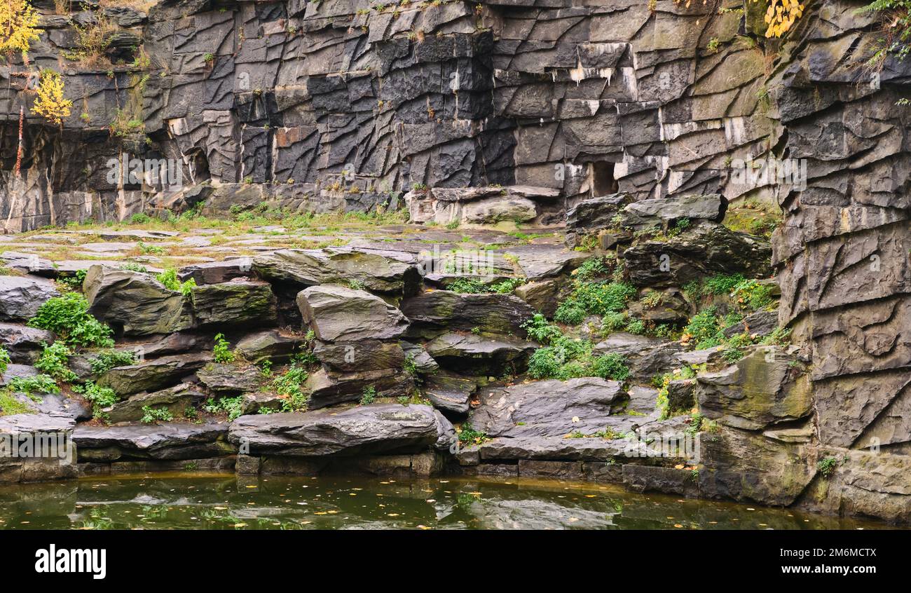 natural stone rock wall mountain with green grass lake shore park Stock ...