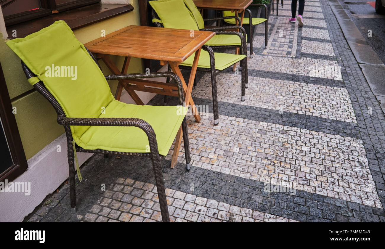 Outdoor empty coffee restaurant terrace wooden tables green chairs ...