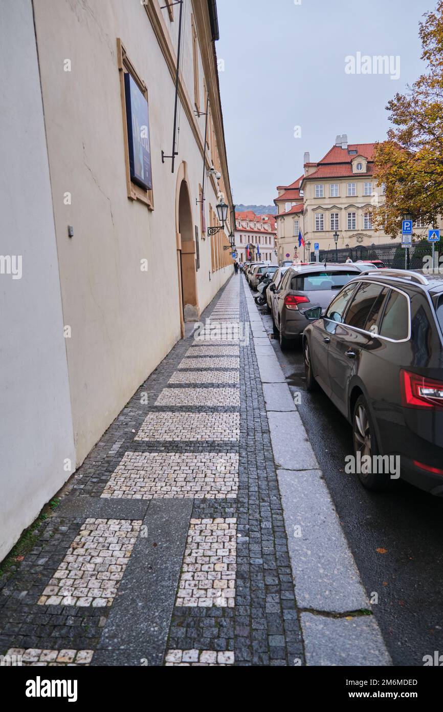 rows of different cars vehicles parked along the roadside sidewalk ...