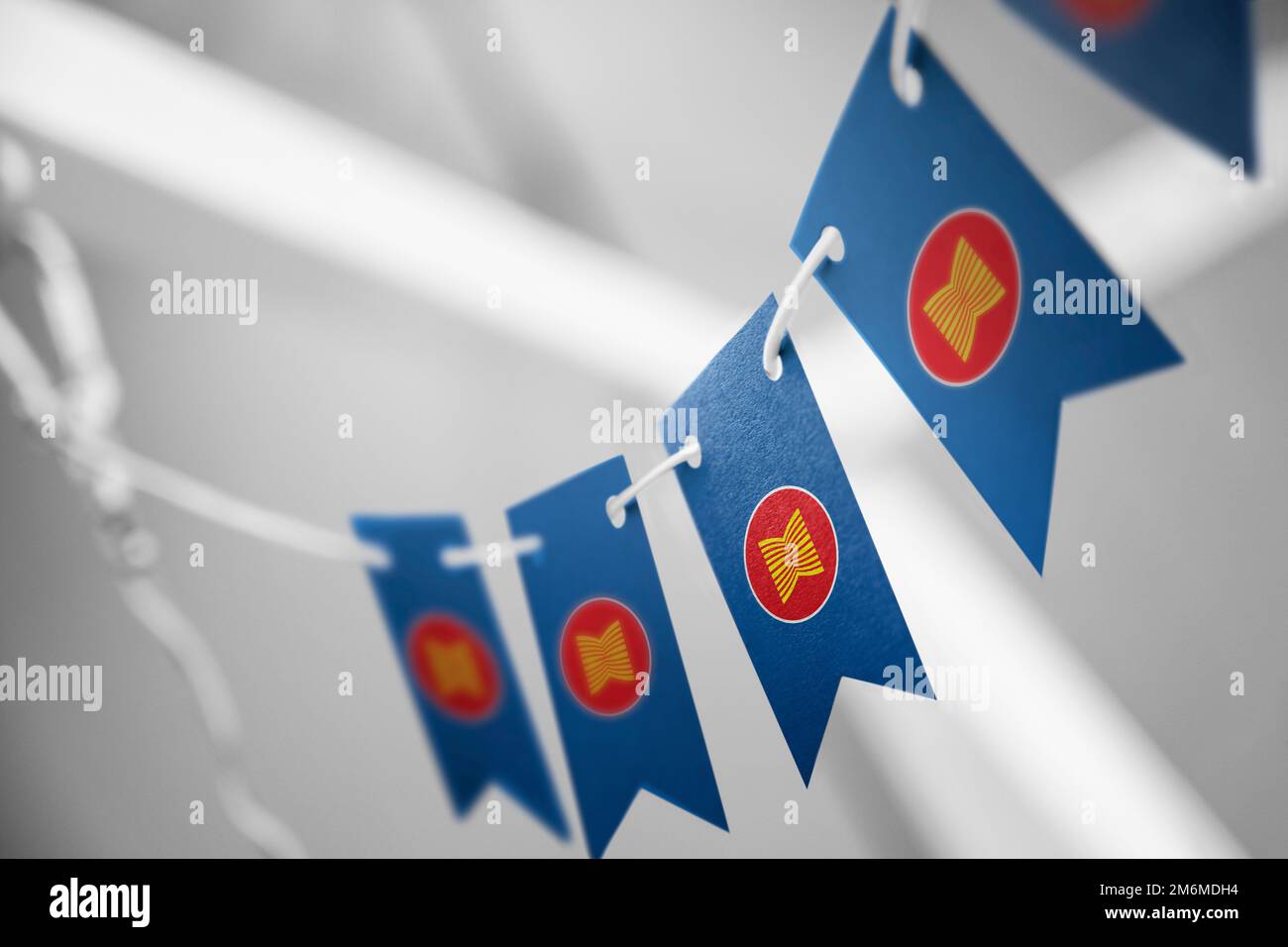 A garland of ASEAN national flags on an abstract blurred background ...
