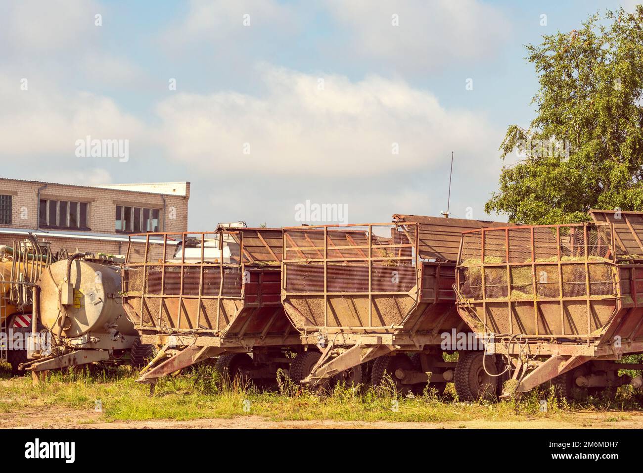 Farm yard with agricultural trailers and tanks Stock Photo - Alamy