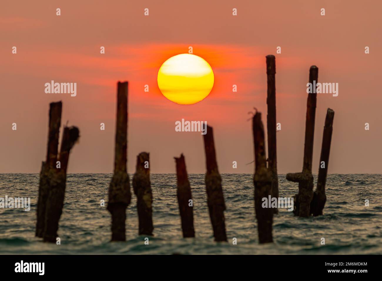 The sun is falling into the sea. The light reflected from the sea and ...