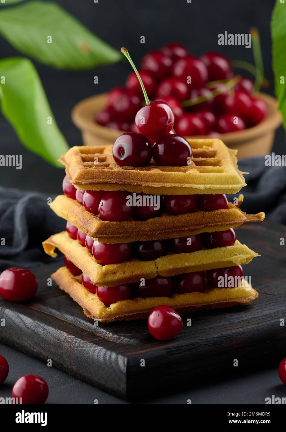 Stack of baked Belgian waffles with ripe red cherries, breakfast Stock ...
