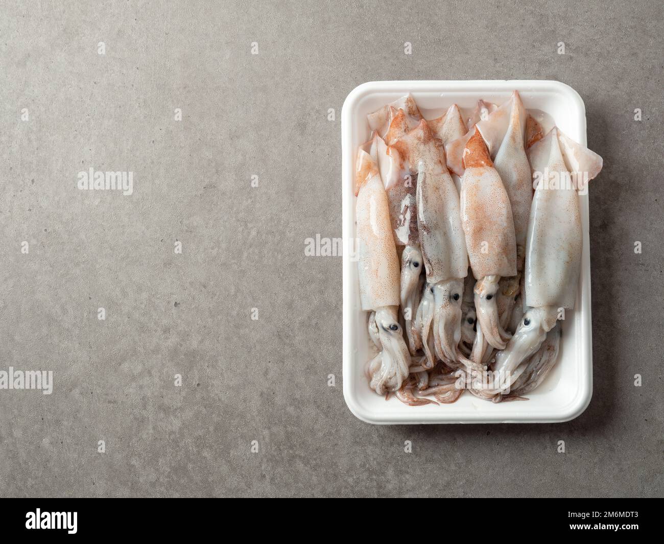 fresh squid in packaging container Stock Photo - Alamy