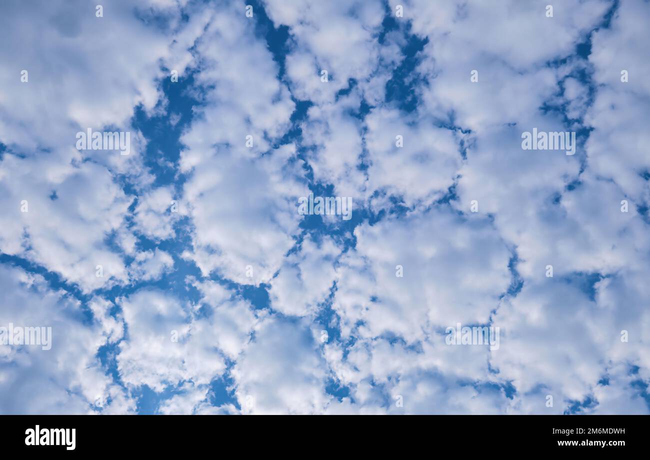 Blue sky and white structured puzzle clouds background Stock Photo - Alamy