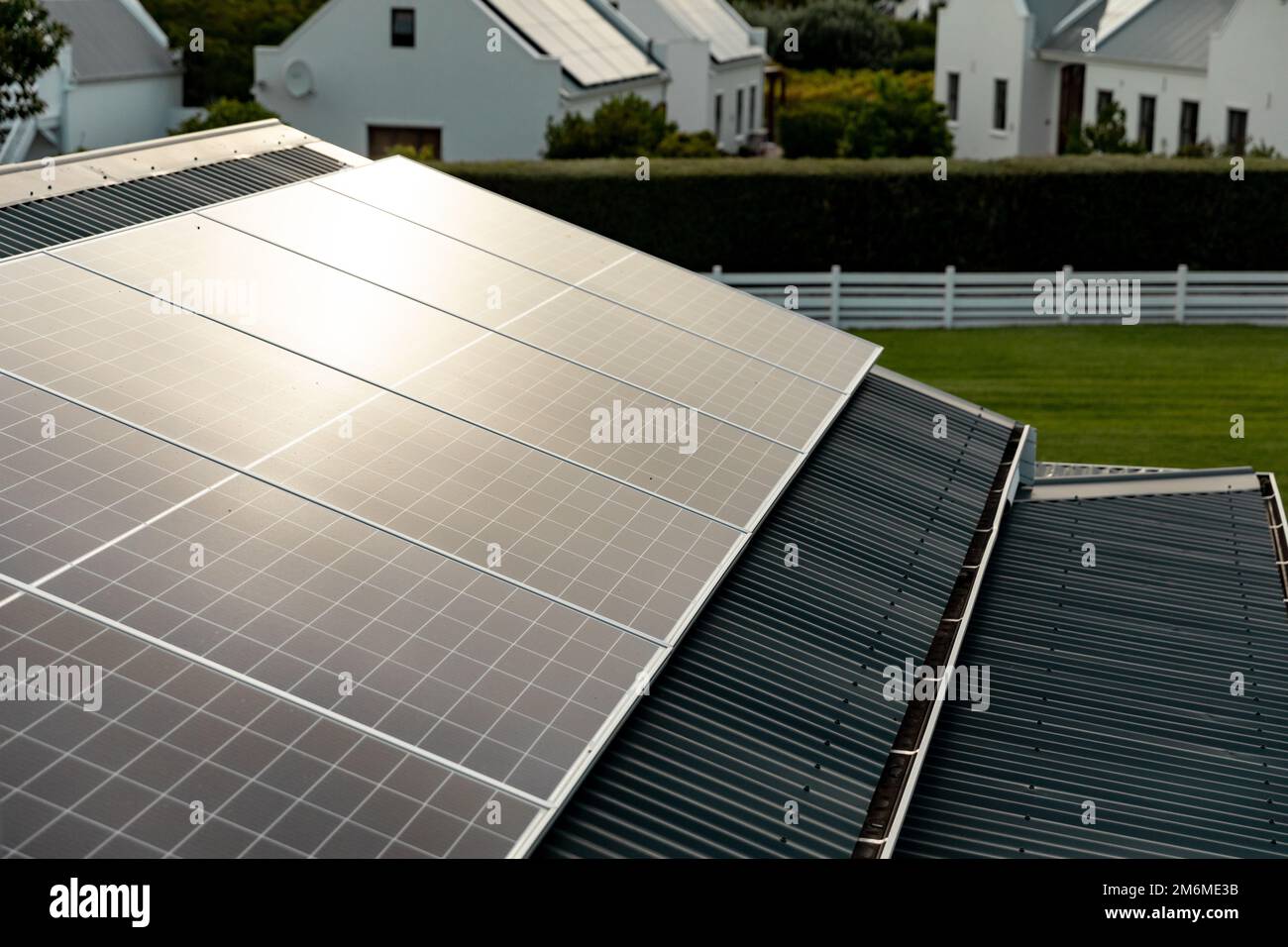 Sunlight falling on solar panels installed on rooftop of houses, copy ...
