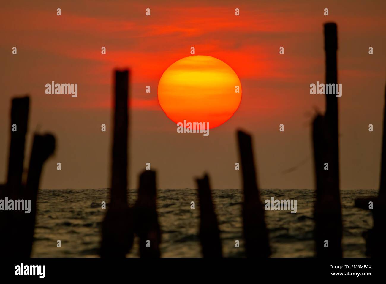 The sun is falling into the sea. The light reflected from the sea and ...