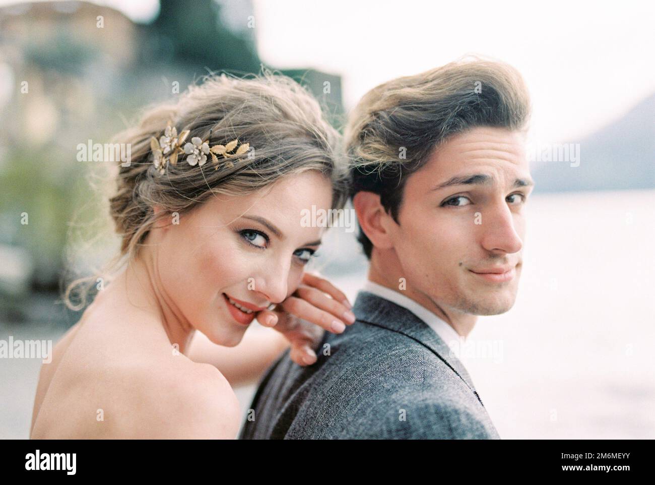 Bride hugs the groom shoulder from behind. Portrait Stock Photo - Alamy