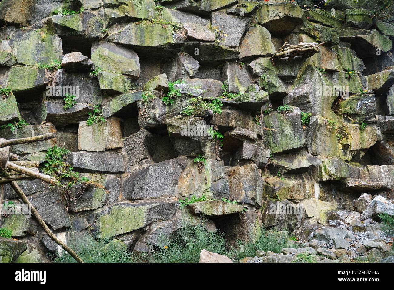 natural stone rock wall mountain with green grass Stock Photo - Alamy