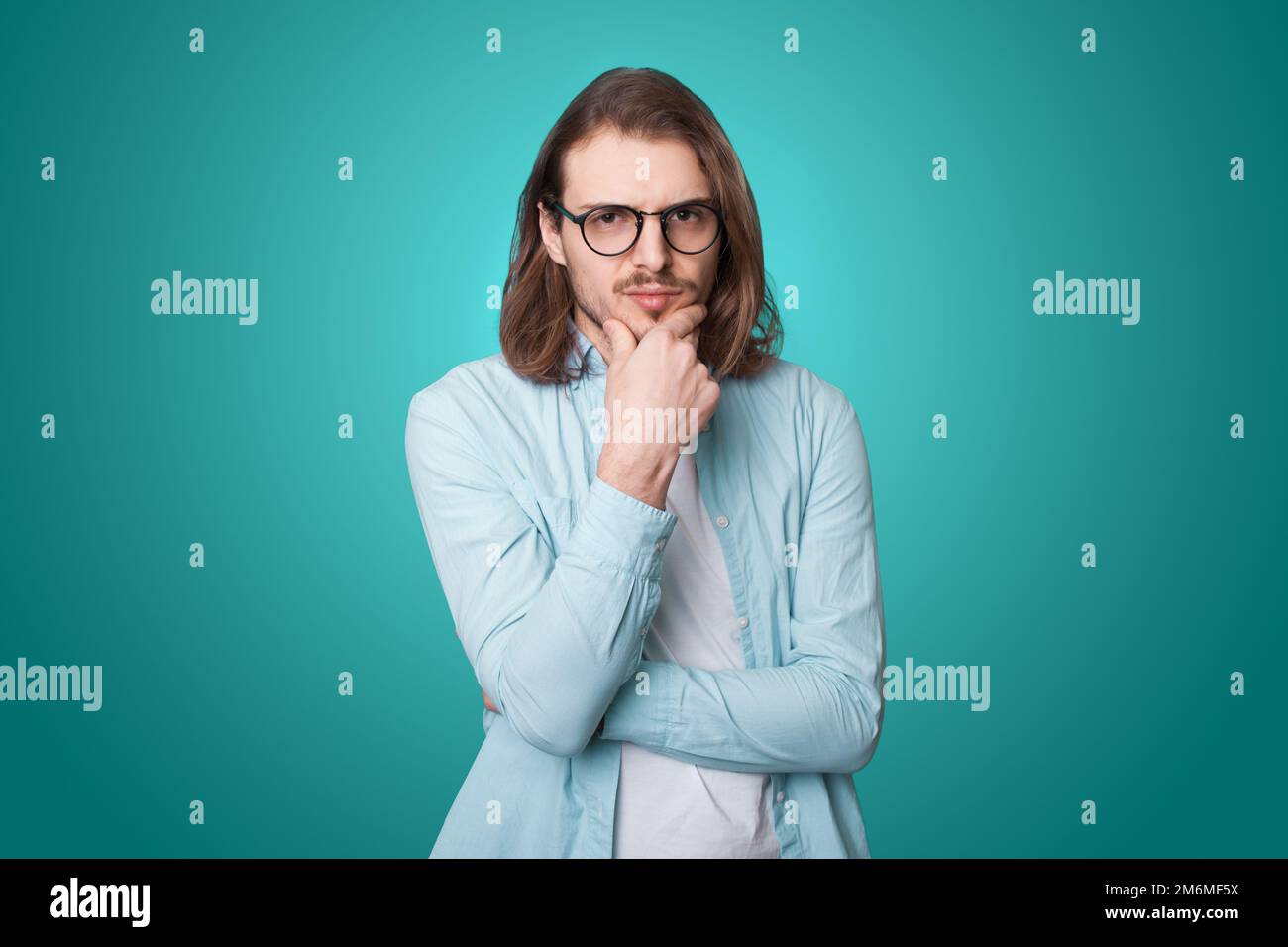 Close-up portrait of serious focused minded man thinking while touching ...