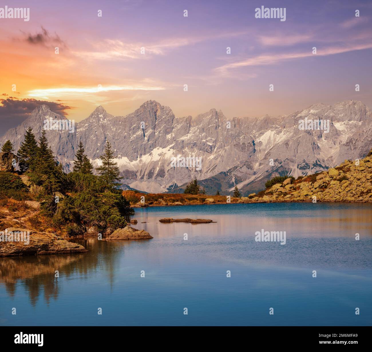 Calm autumn Alps mountain lake with clear transparent water and ...