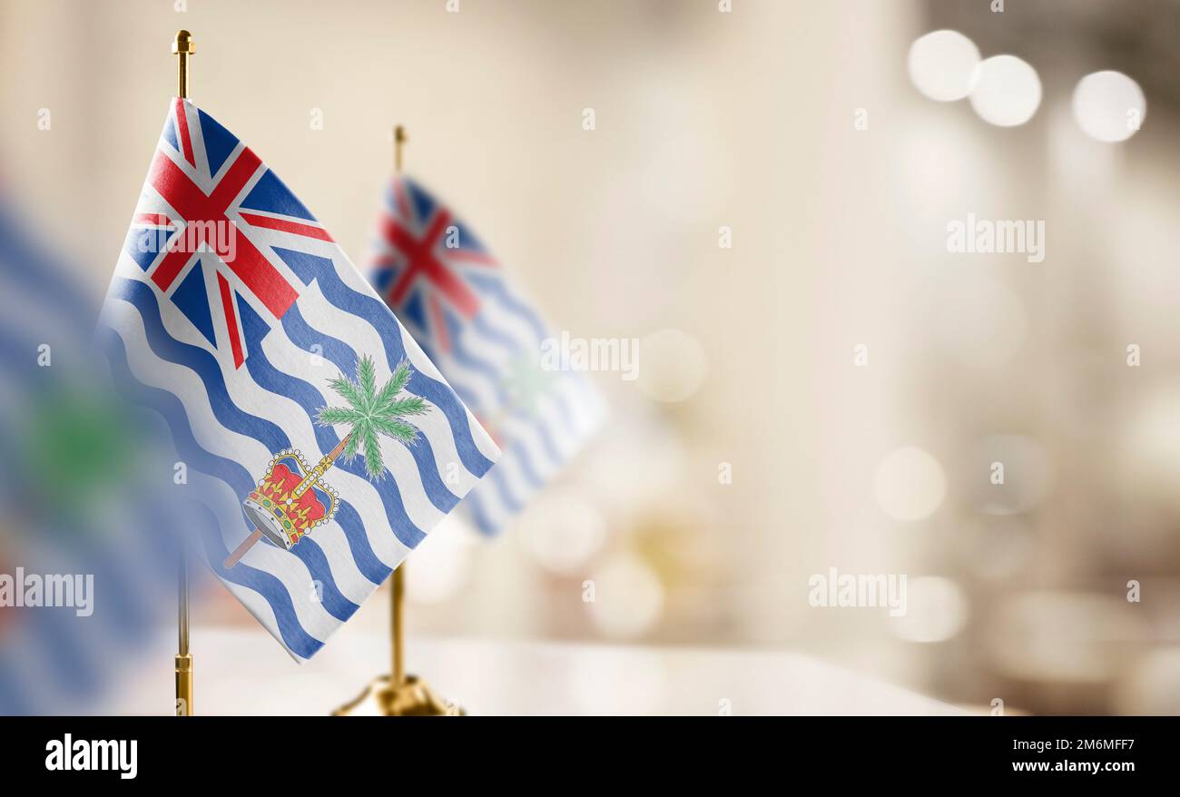 Small flags of the British Indian Ocean Territory on an abstract blurry ...