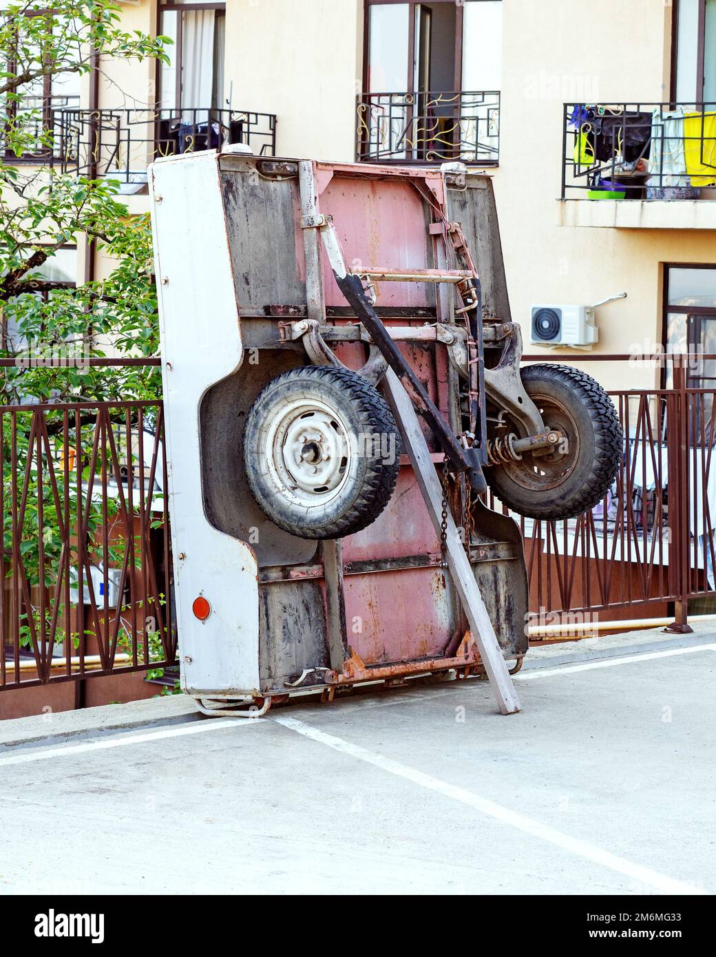 Car trailer. Overturned cart. Overturned wheelbarrow. An overturned car ...