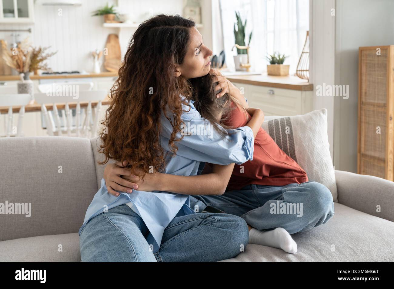 Loving mother comforting hugging unhappy teenage daughter, mom supporting depressed teen girl ...