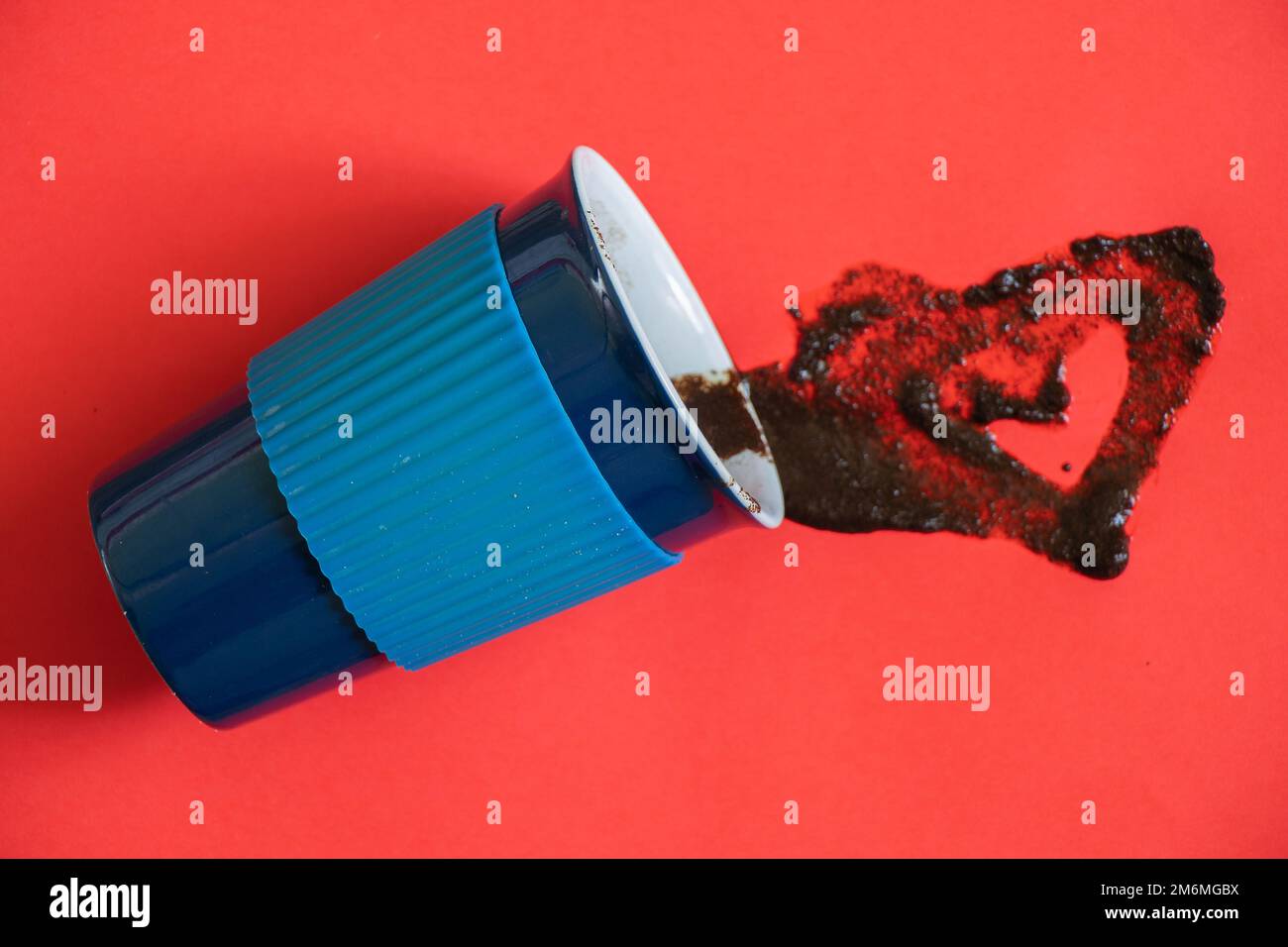 cup lies on a red background with spilled coffee Stock Photo - Alamy