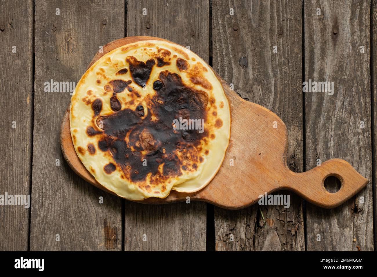 burnt fried pancakes on a blackboard on a table in the kitchen Stock ...