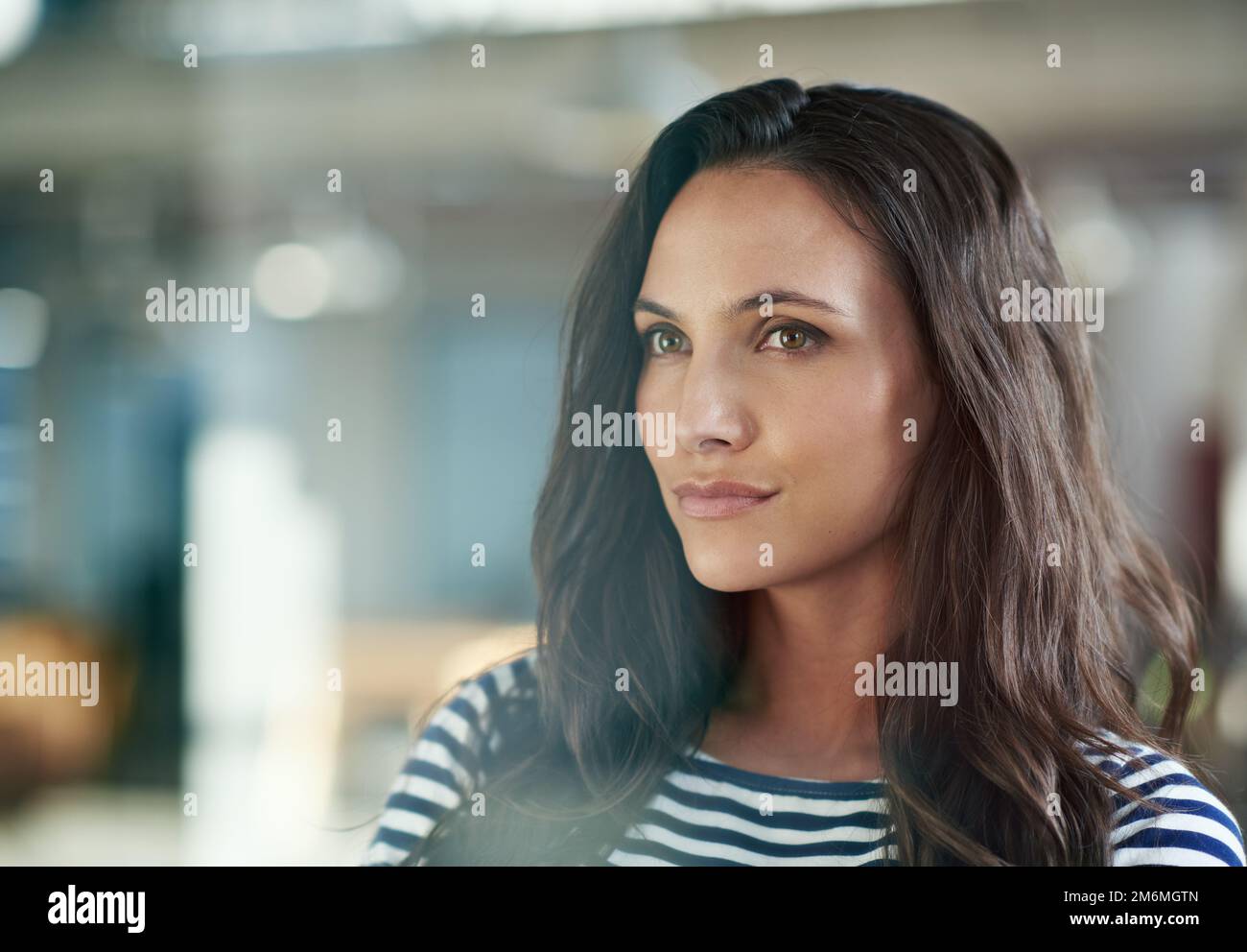 Shes the model employee. a casually-dressed businesswoman standing in ...