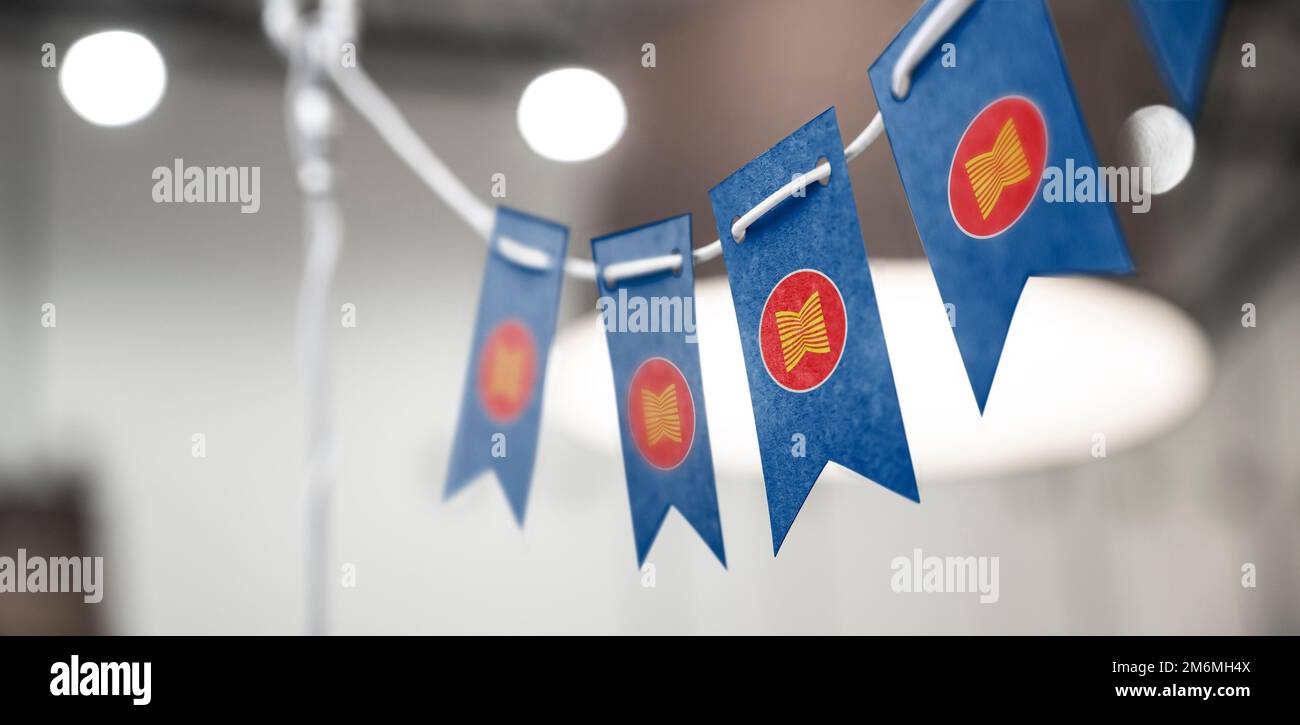 A garland of ASEAN national flags on an abstract blurred background ...
