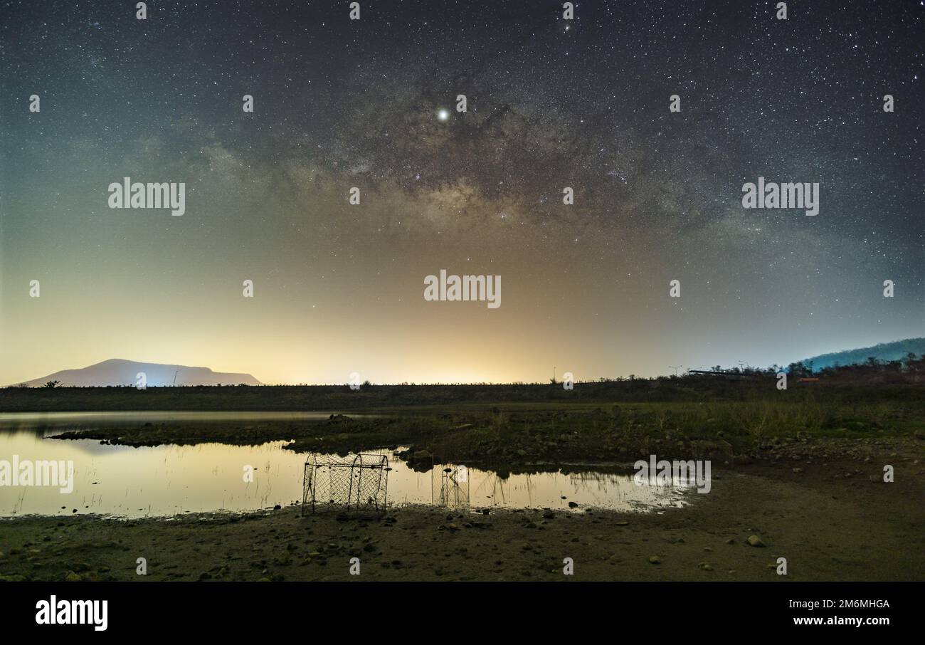 The stars in the sky reflect the light at night. The Milky Way above ...