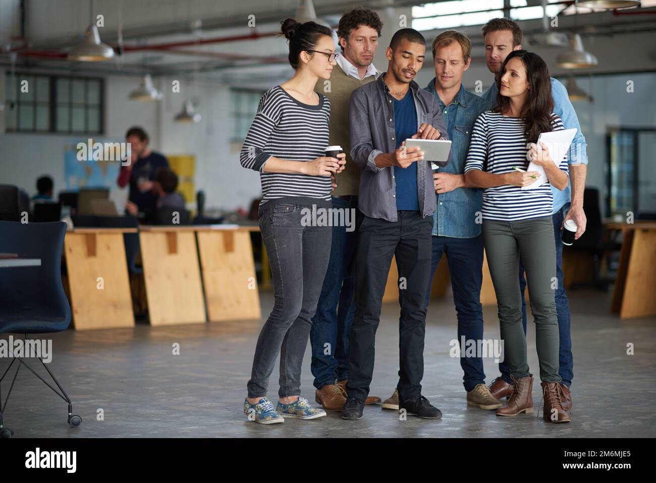 Focussed on the new online campaign. Group of creative staff gathered ...