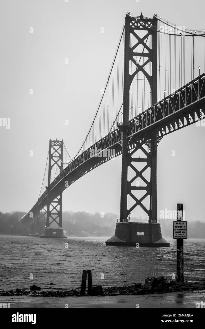A grayscale of the Mount Hope Bridge in a foggy morning, Bristol, Rhode ...
