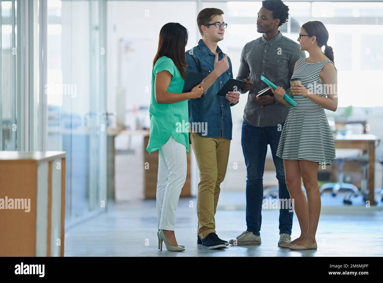 Getting down to business in the office. a diverse group of colleagues ...
