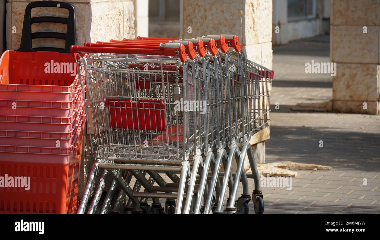 Row of Empty shopping trolleys and baskets near supermarket Stock Photo ...