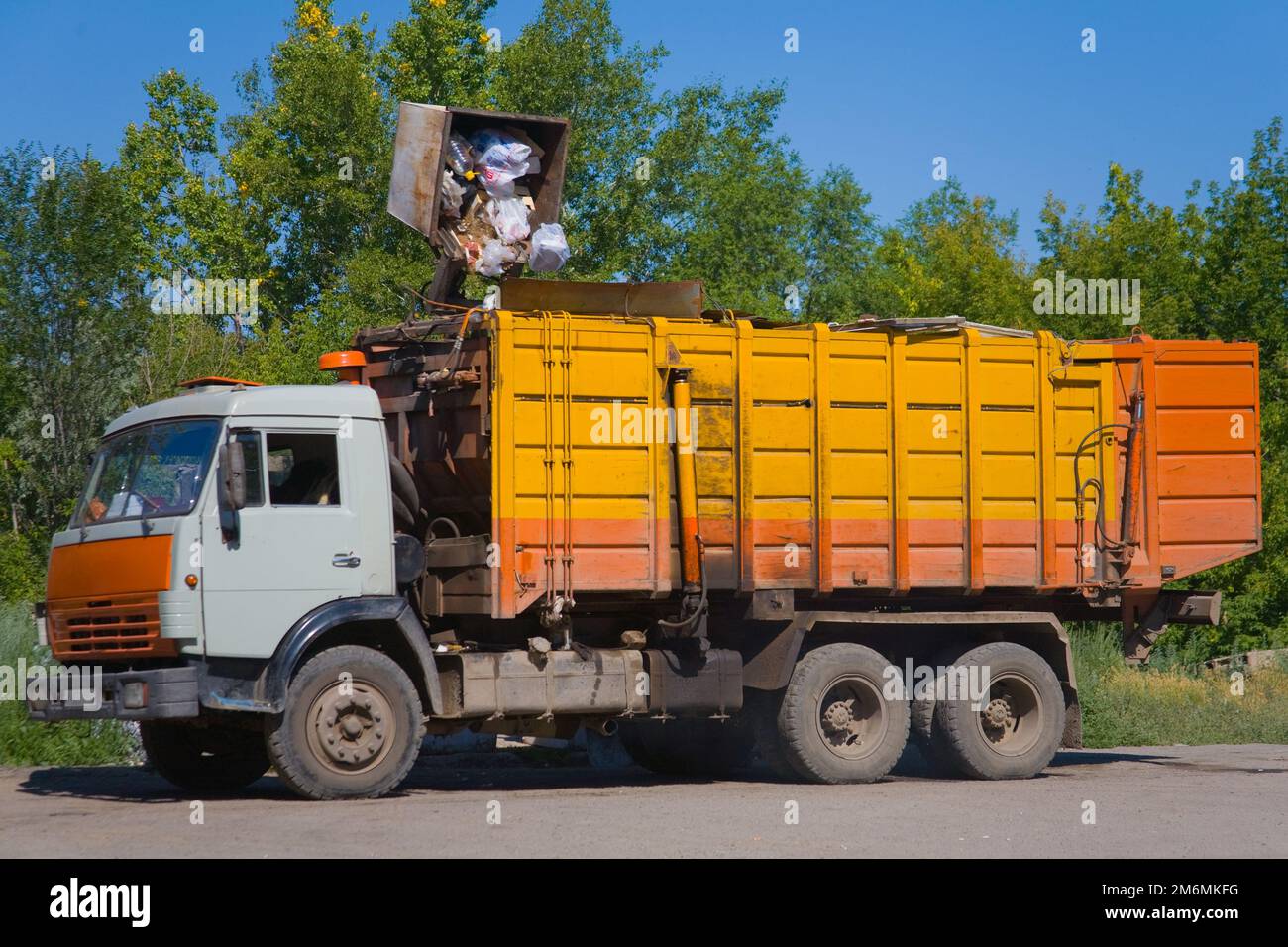 Heavy yellow garbage truck KAMAZ Stock Photo - Alamy