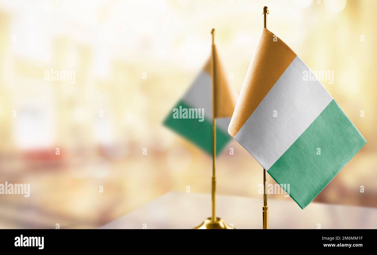 Small Flags Of The Cote Divoire On An Abstract Blurry Background Stock