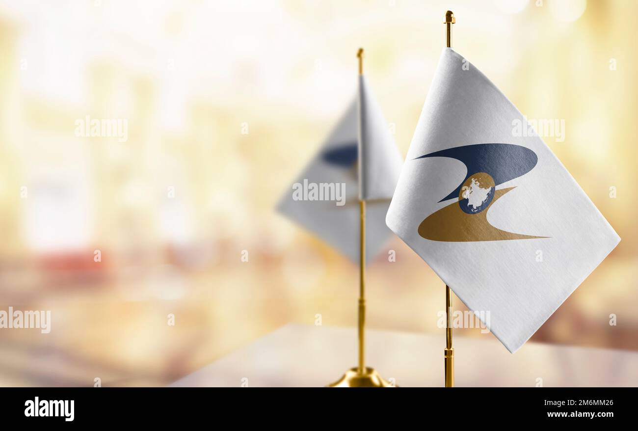 Small flags of the Eurasian Economic Union on an abstract blurry ...