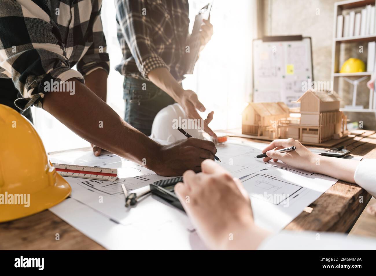 Architect Team Working With Blueprints For Architectural Construction Plan Engineer Sketching A