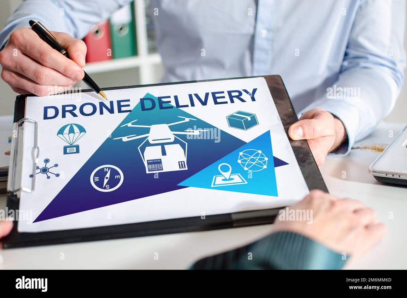 Businessman showing drone delivery concept on a clipboard Stock Photo ...