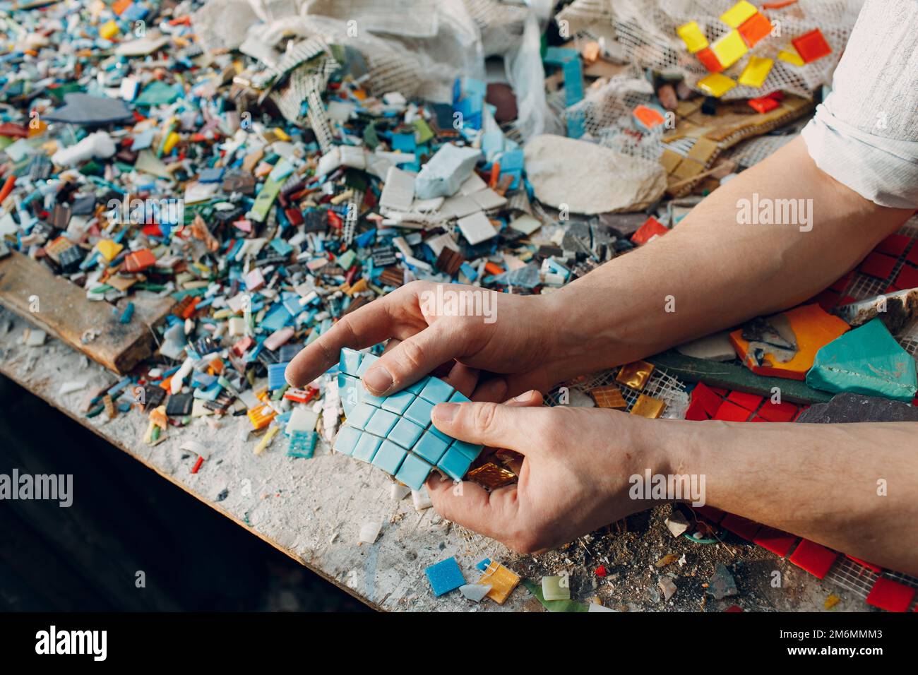 Man mosaics master chooses select smalt glass pieces for mosaic panel ...