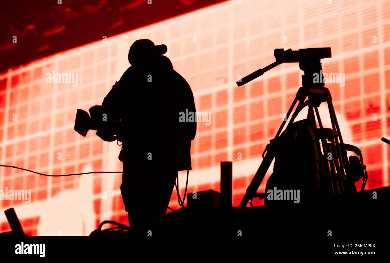 Cameraman silhouette in stage lights Stock Photo - Alamy