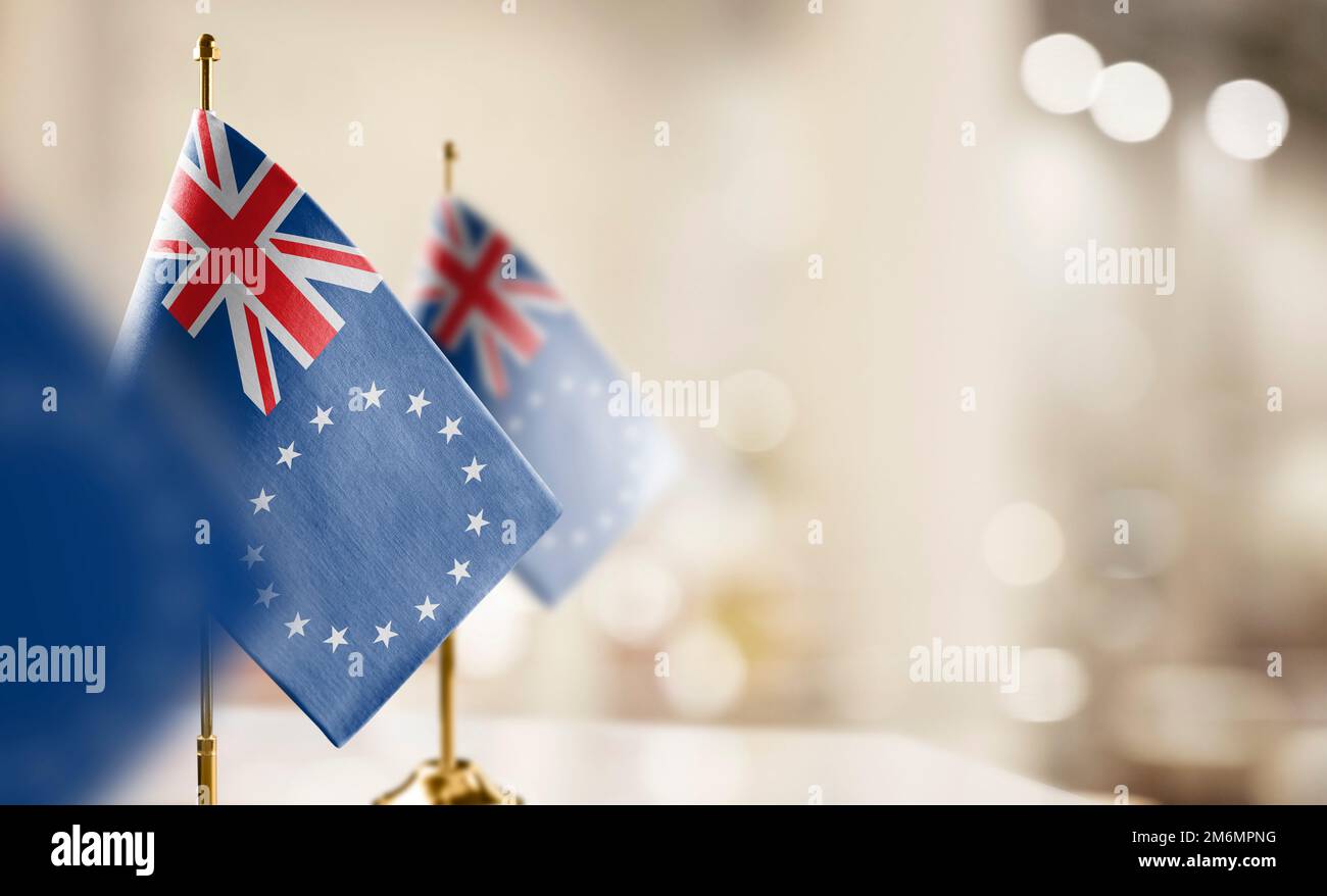 Small flags of the Cook Islands on an abstract blurry background Stock ...