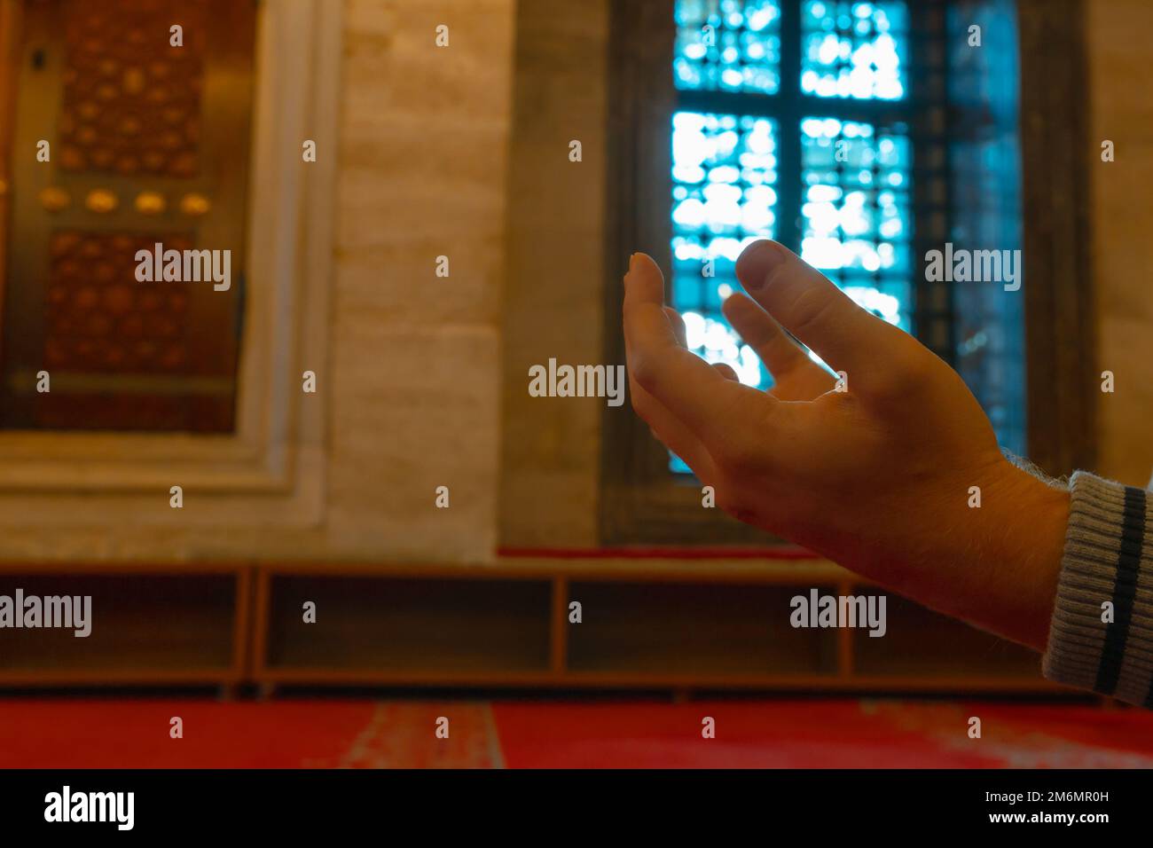 Muslim man raising his hands for praying or dua. Islamic background ...
