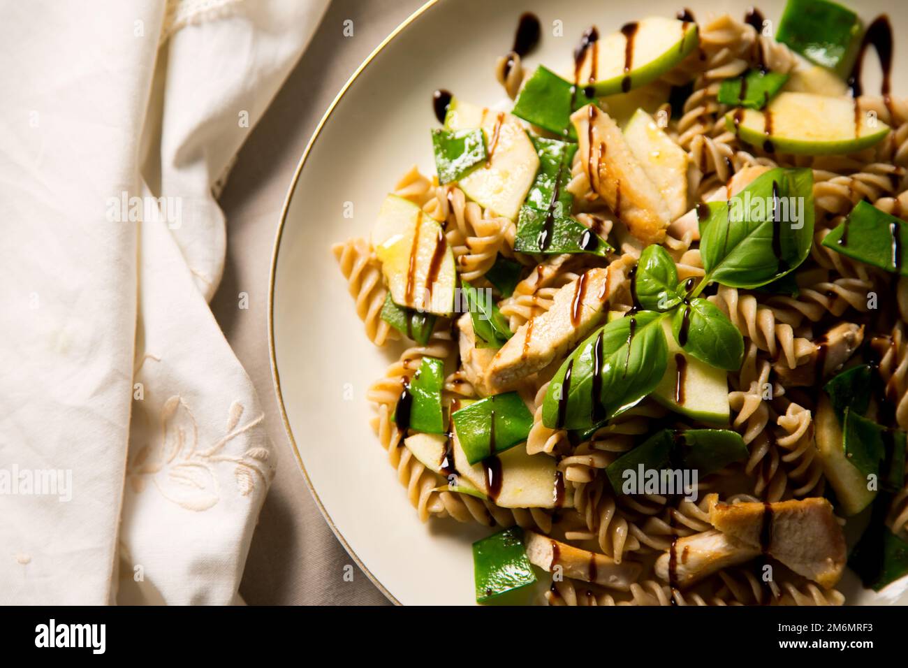 Pasta salad with apple, basil, parmesan and chicken Stock Photo - Alamy