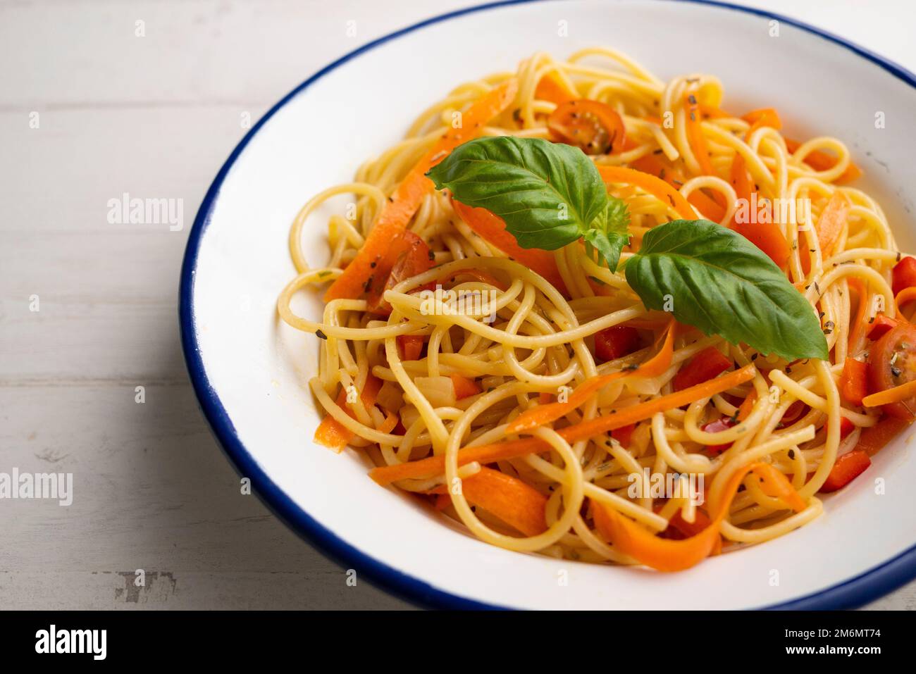 Spaghettis with carrot and basil. Fresh italian pasta with vegetables ...